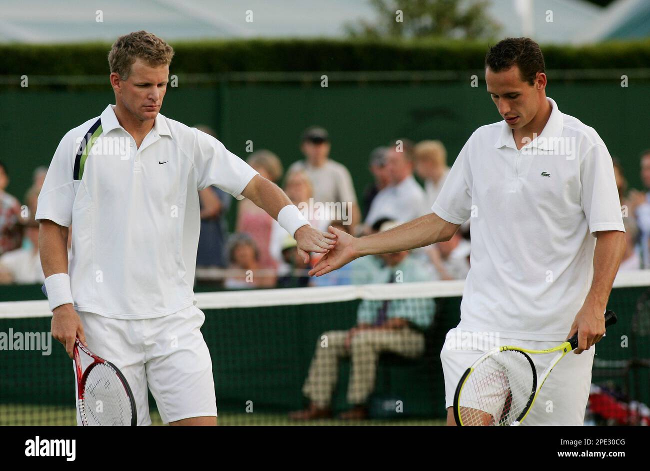 Mark Knowles, of the Bahamas, left, slaps hands with teammate Michael ...