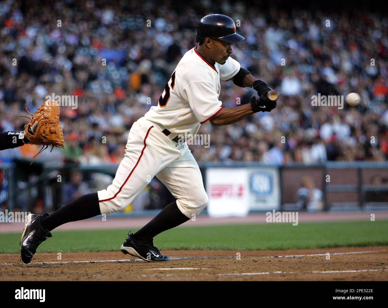 San Francisco Giants' Jason Ellison drives in a run with a bunt single ...