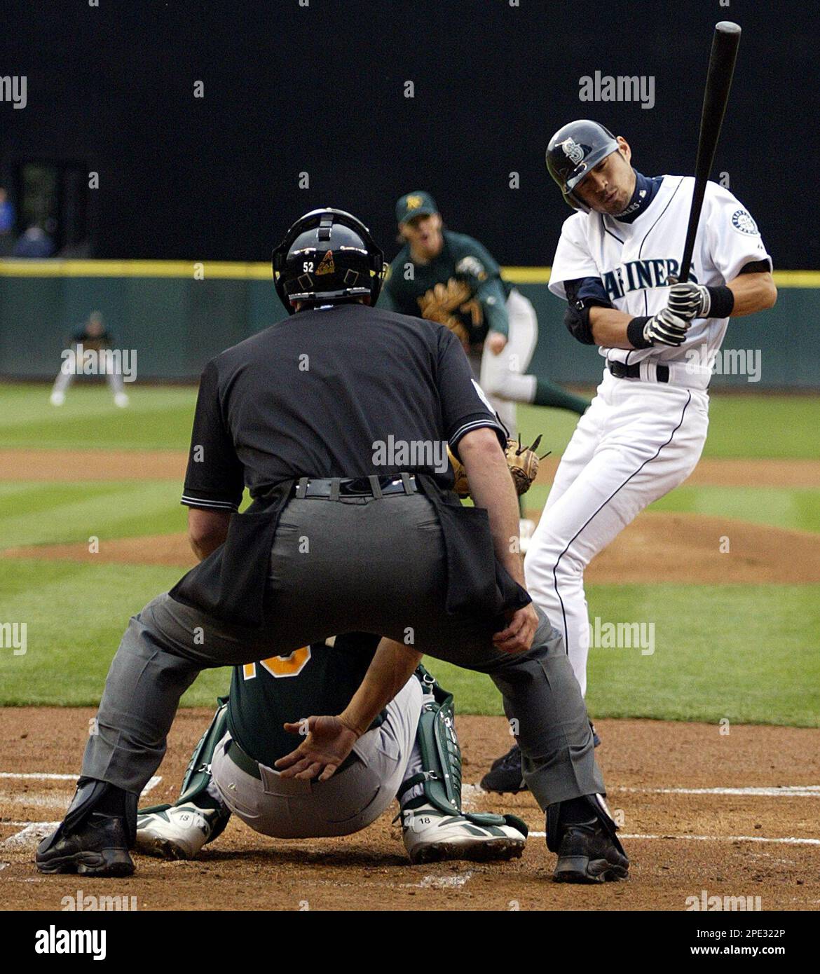 Seattle Mariners' Ichiro Suzuki, right, is brushed back by Oakland ...