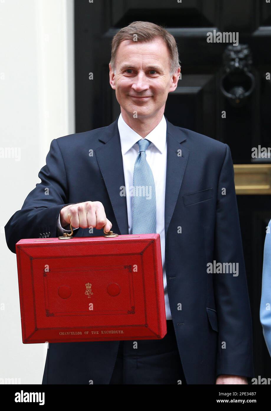 Jeremy Hunt leaves Downing Street with the despatch box to present his ...