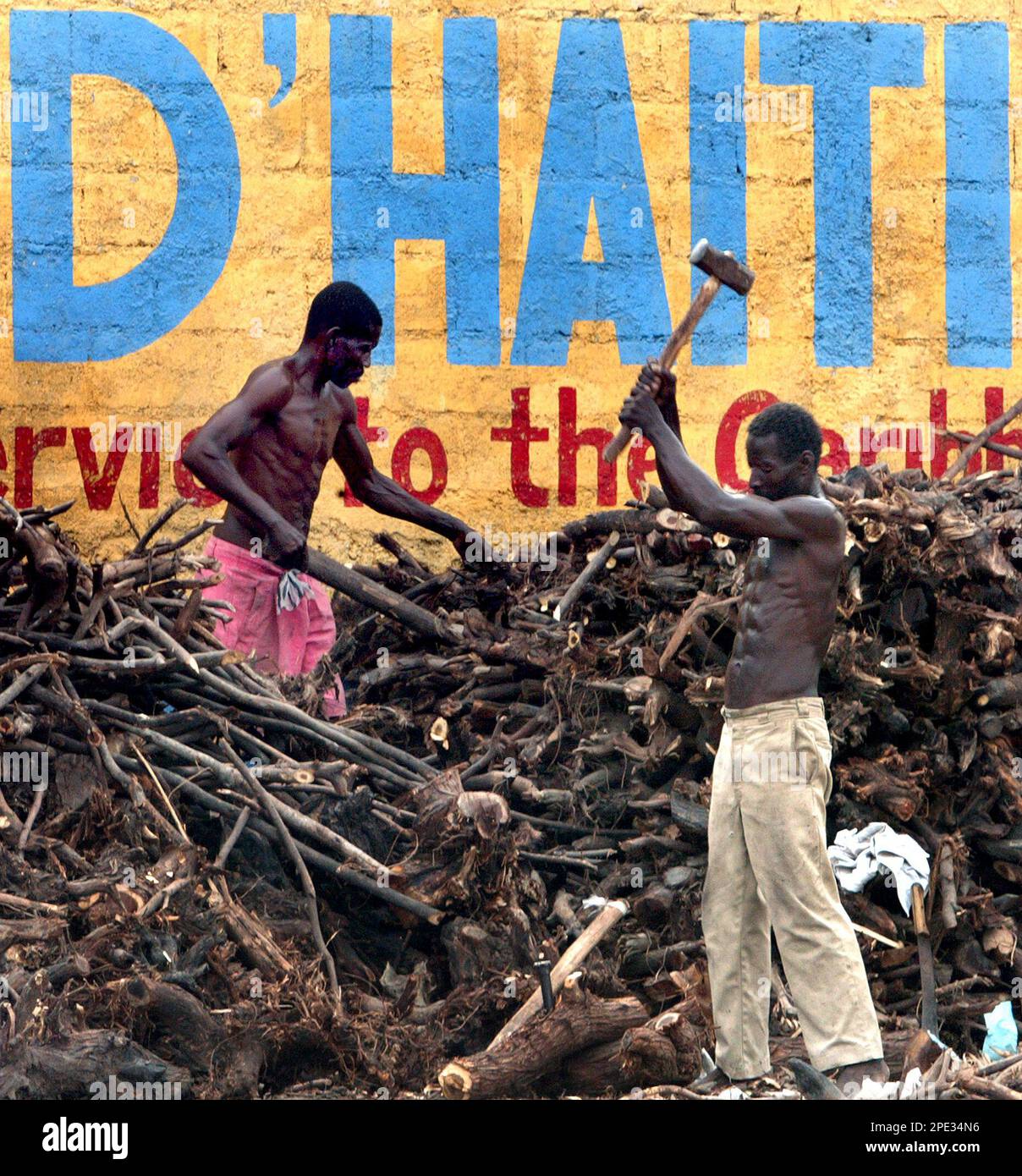 Two Haitian men work in the Lesaline neighborhood of Port-au-Prince ...