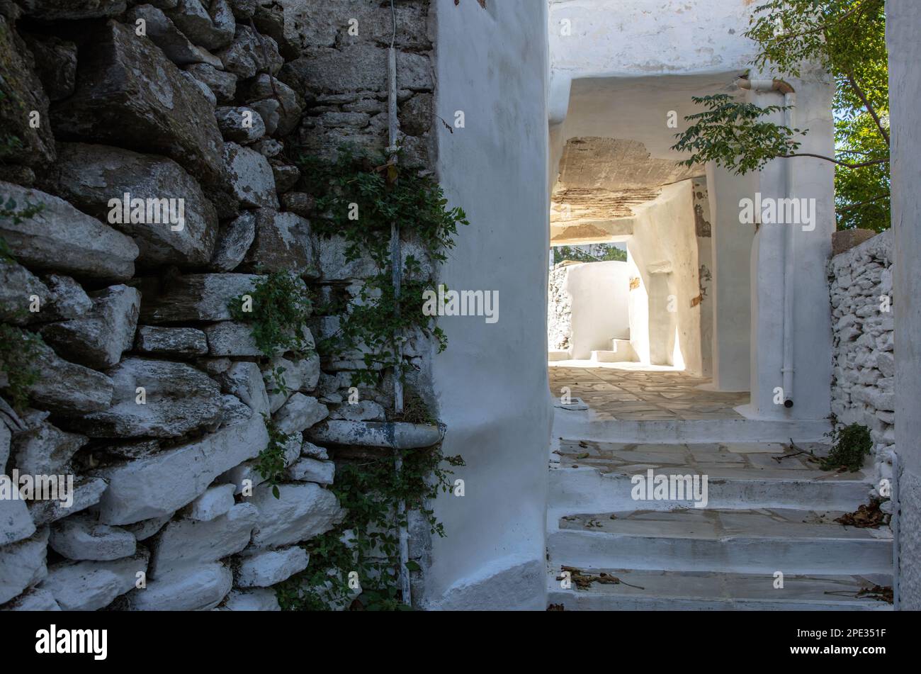 Greece. Paved stairway old wall covers the building exterior corridor ...