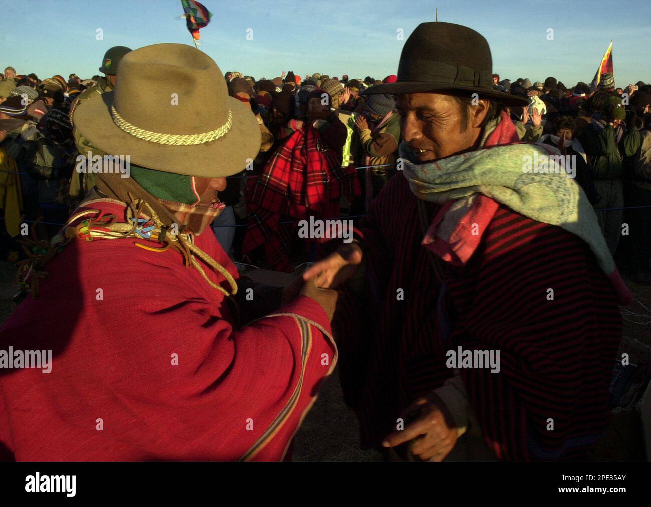 Mario Mamani and Felix Condori, indigenous Aymara, greet each other as ...