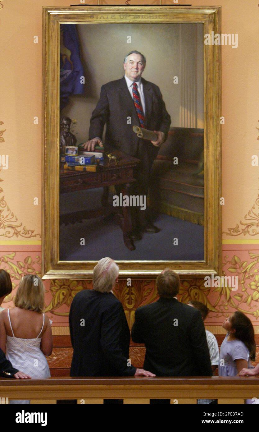 Spectators admire the portrait of former Republican Gov. John Engler in ...