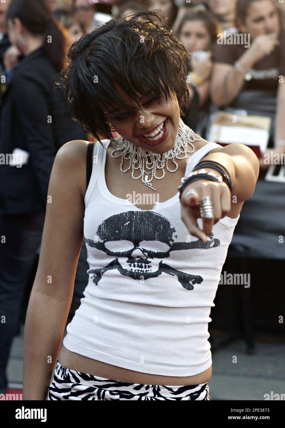 Singer Fefe Dobson jokes around with photographers as she arrives at ...