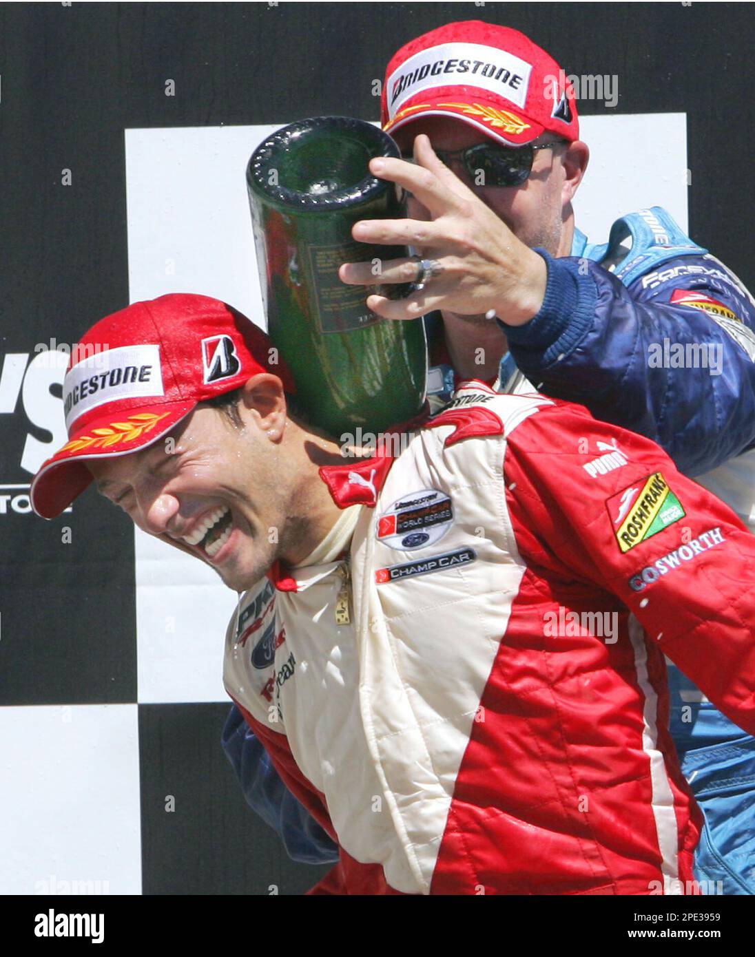 Brazilian Champ Car driver Cristiano da Matta, left, reacts as Canadian ...