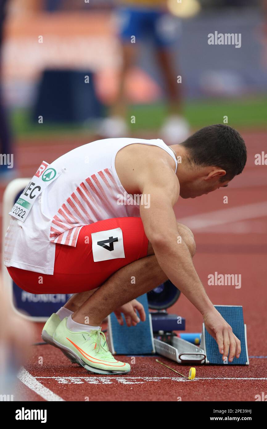 Dominik KOPEĆ checking his blocks at the start of the 4*100m heats at ...