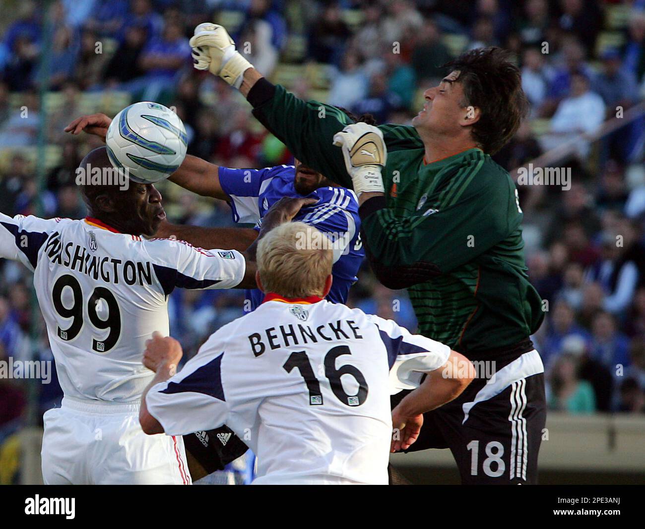 San Jose Earthquakes goalkeeper Pat Onstad, right, punches the ball out ...
