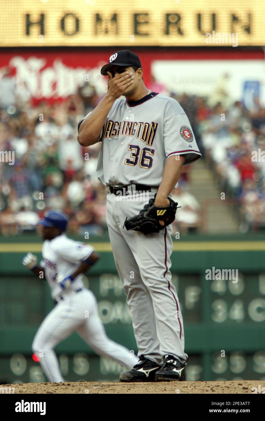 Washington Nationals pitcher Tony Armas wipes his face as Texas Rangers ...