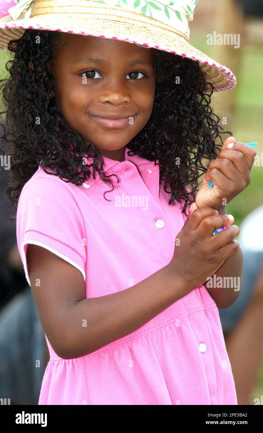 Aaliyah Williams, 3, holds fists full of candy at the Juneteenth Parade ...