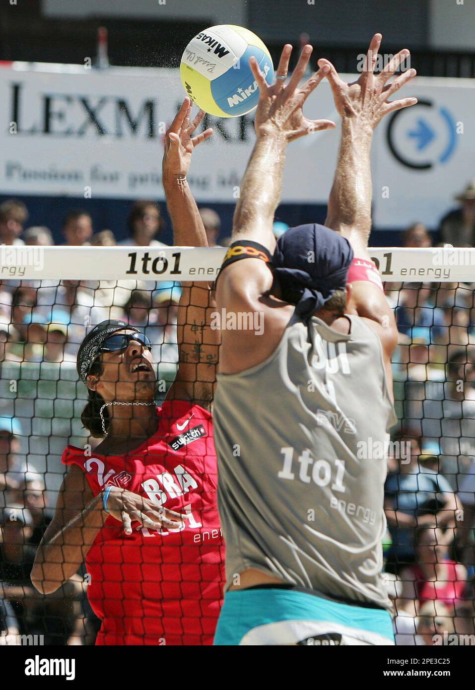 Brazil's Harley Marquez, left, smashes the ball against Switzerland's Sascha Heyer, during their ...