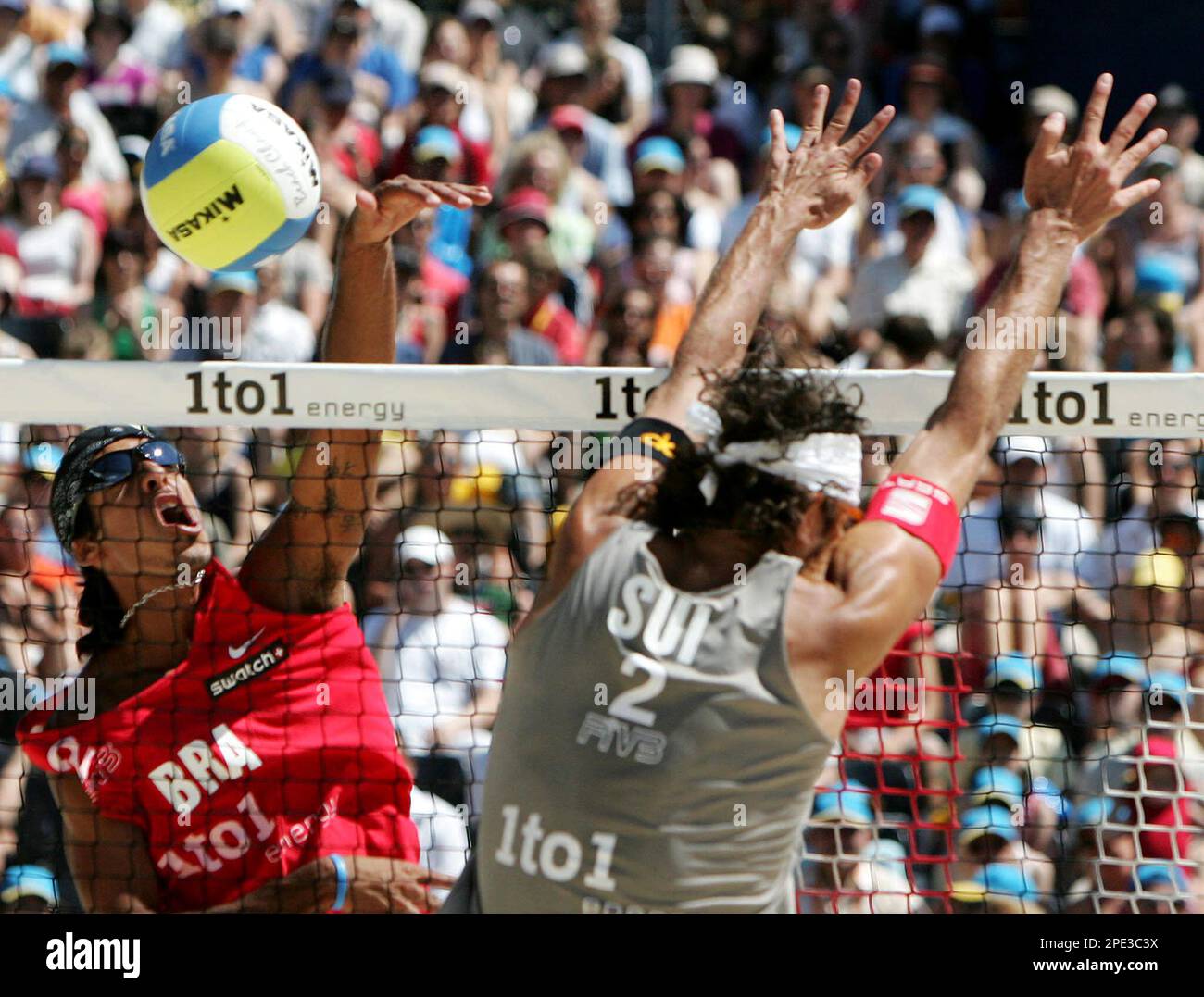 Brazil's Harley Marquez, left, smashes the ball against Switzerland's Paul Laciga, during their ...