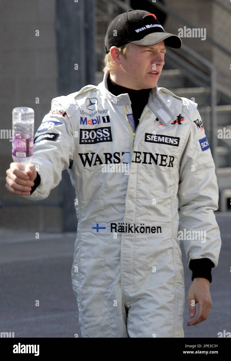 McLaren driver Kimi Raikkonen walks to his garage for Formula One ...