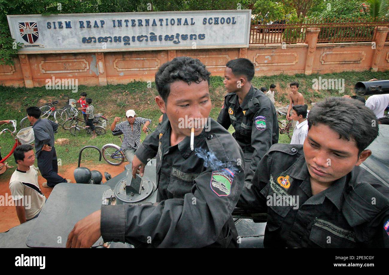 Cambodian soldiers stands watch outside the Siem Reap International School following a hostage ...