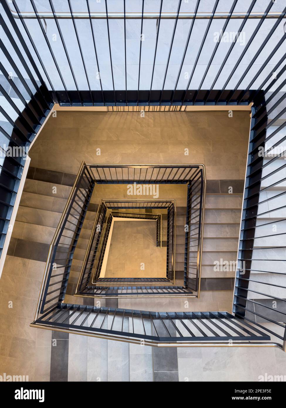 Bird's-eye view from top to bottom of stairwell in tall block of flats ...