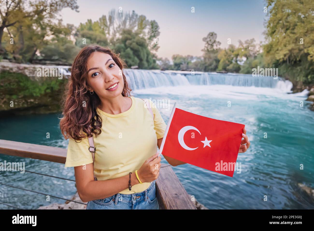 Girl with turkish flag standing near Manavgat waterfall. Travel ...