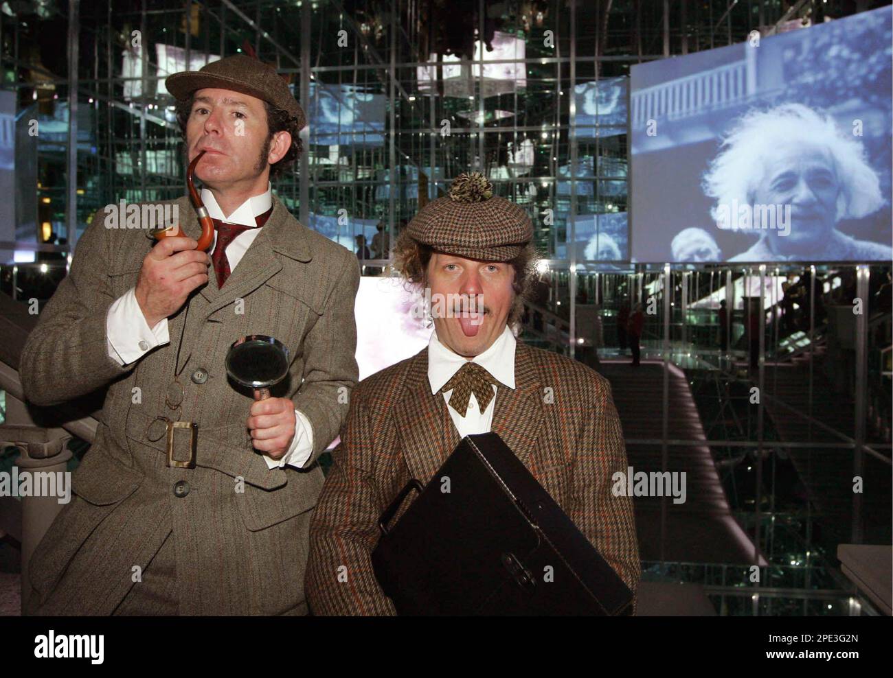 Philip Porter, acting as Sherlock Holmes, right, of the British ...