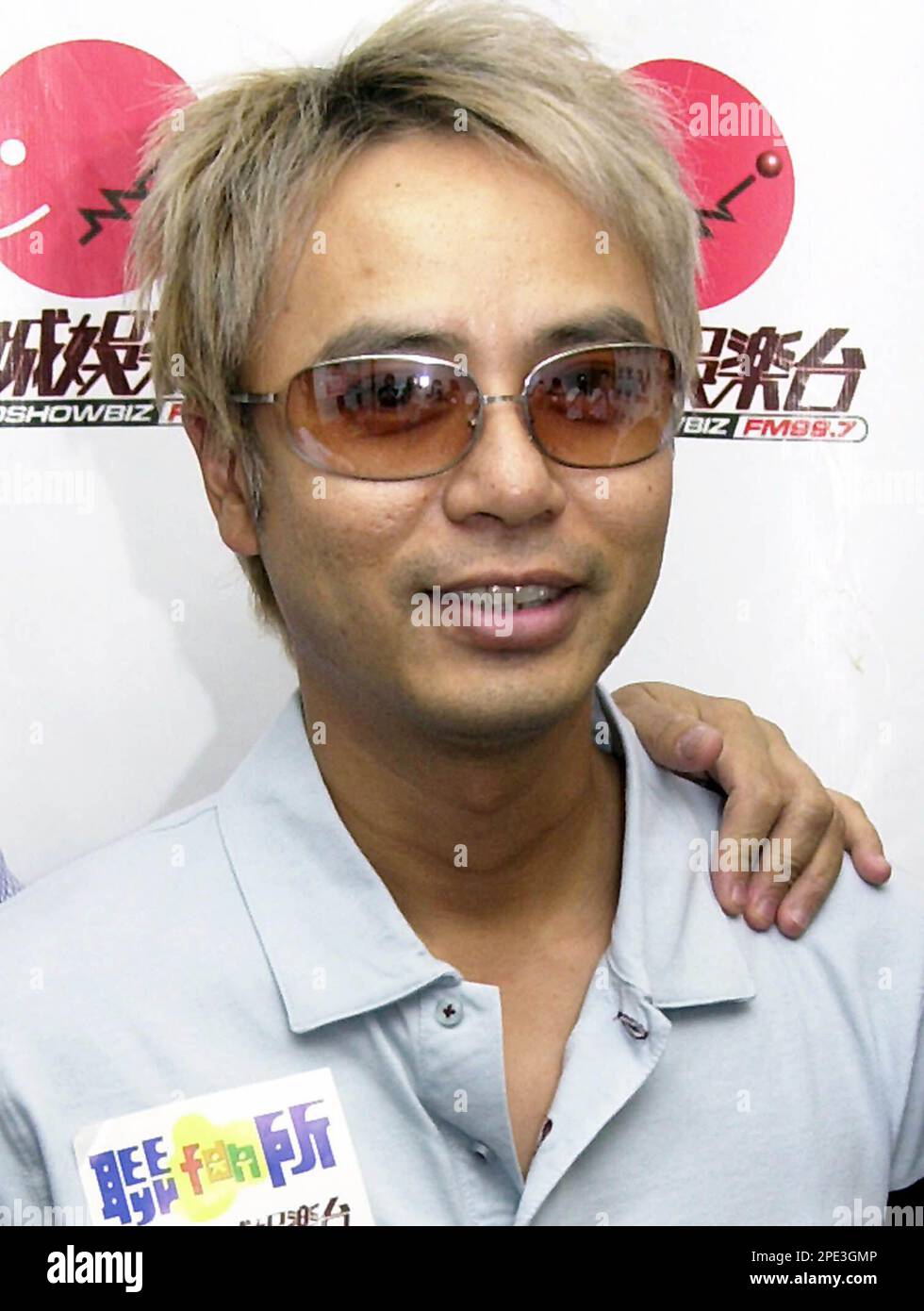 Hong Kong singer Hacken Lee poses for photographers after being ...