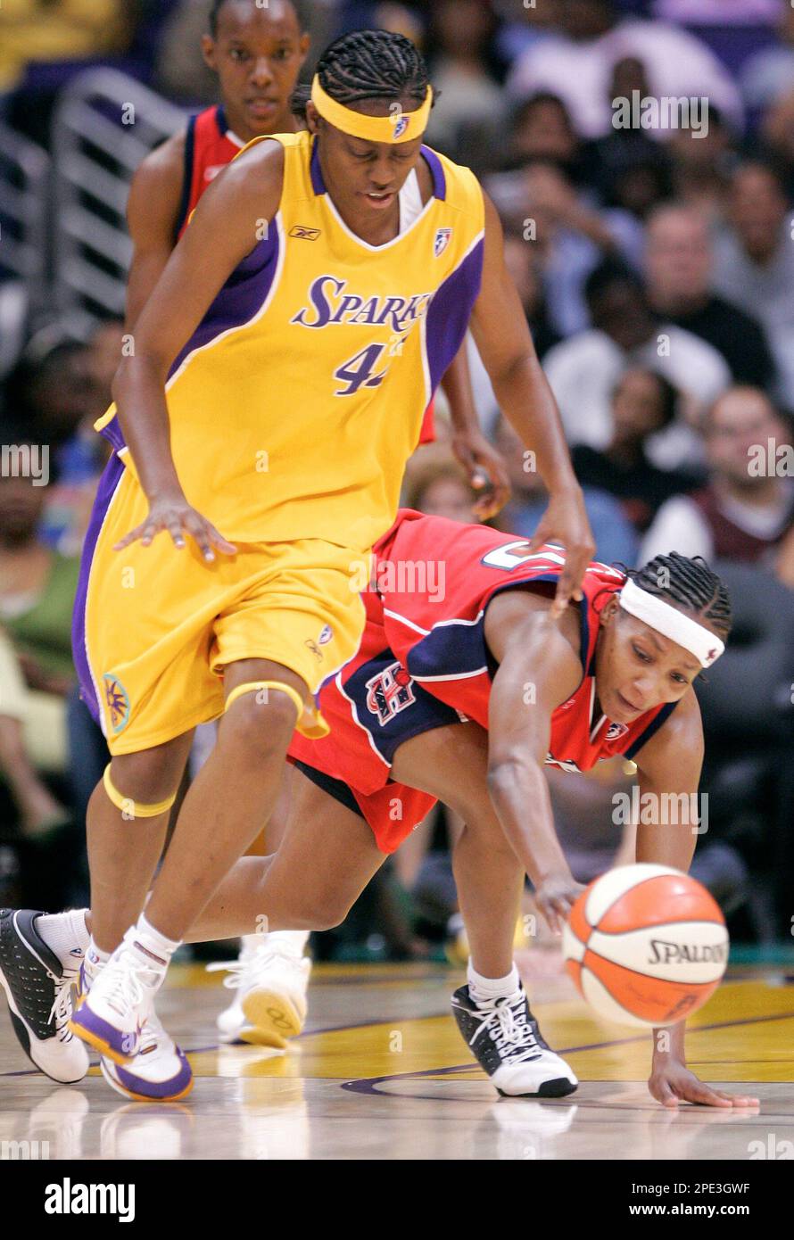 Houston Comets' Dominique Canty, right, goes after a loose ball along ...
