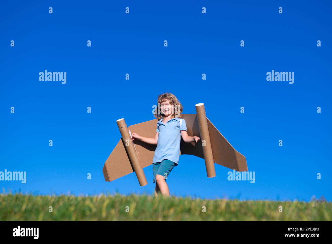 Happy child playing with toy jetpack. Kid pilot having fun outdoor ...