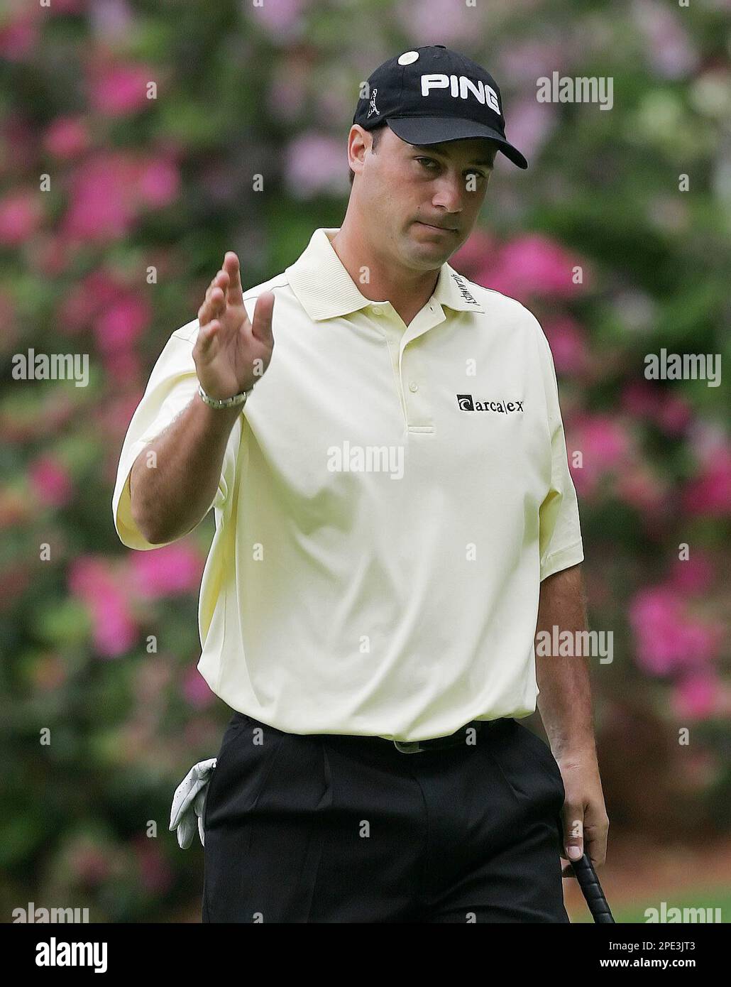 ** FILE ** Chris DiMarco waves after making his putt on the 13th green ...