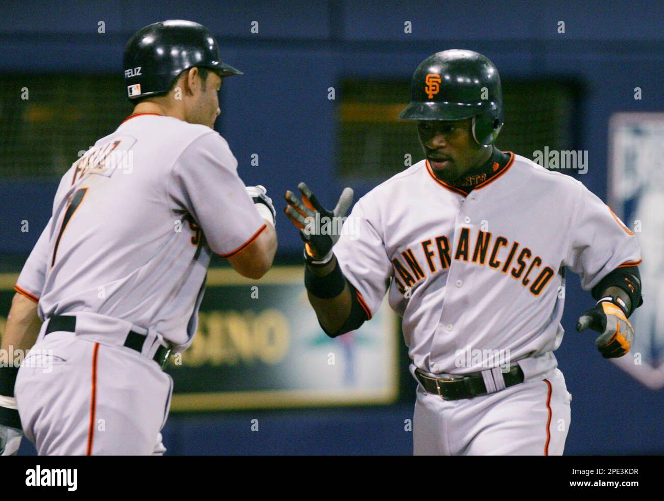 San Francisco Giants' Ray Durham, right, is welcomed home by Pedro ...