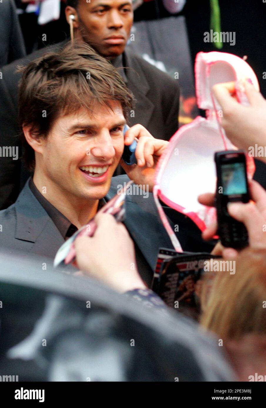 A fan tries to hand over a bra to U.S. actor Tom Cruise as he arrives ...