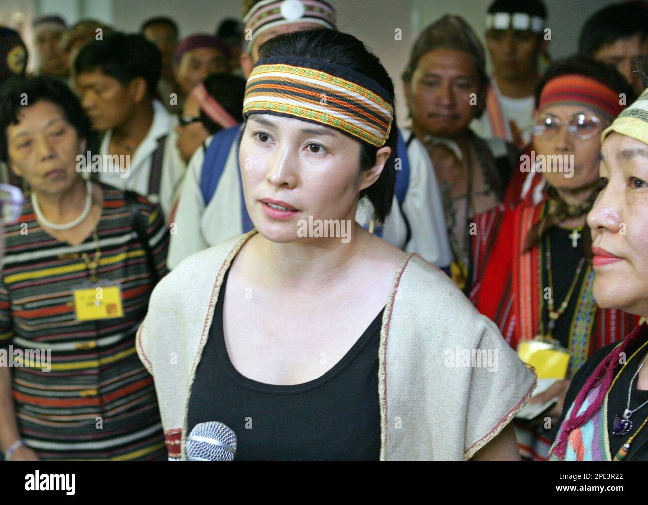 Taiwanese aboriginal lawmaker May Chin, center, speaks to a reporter ...