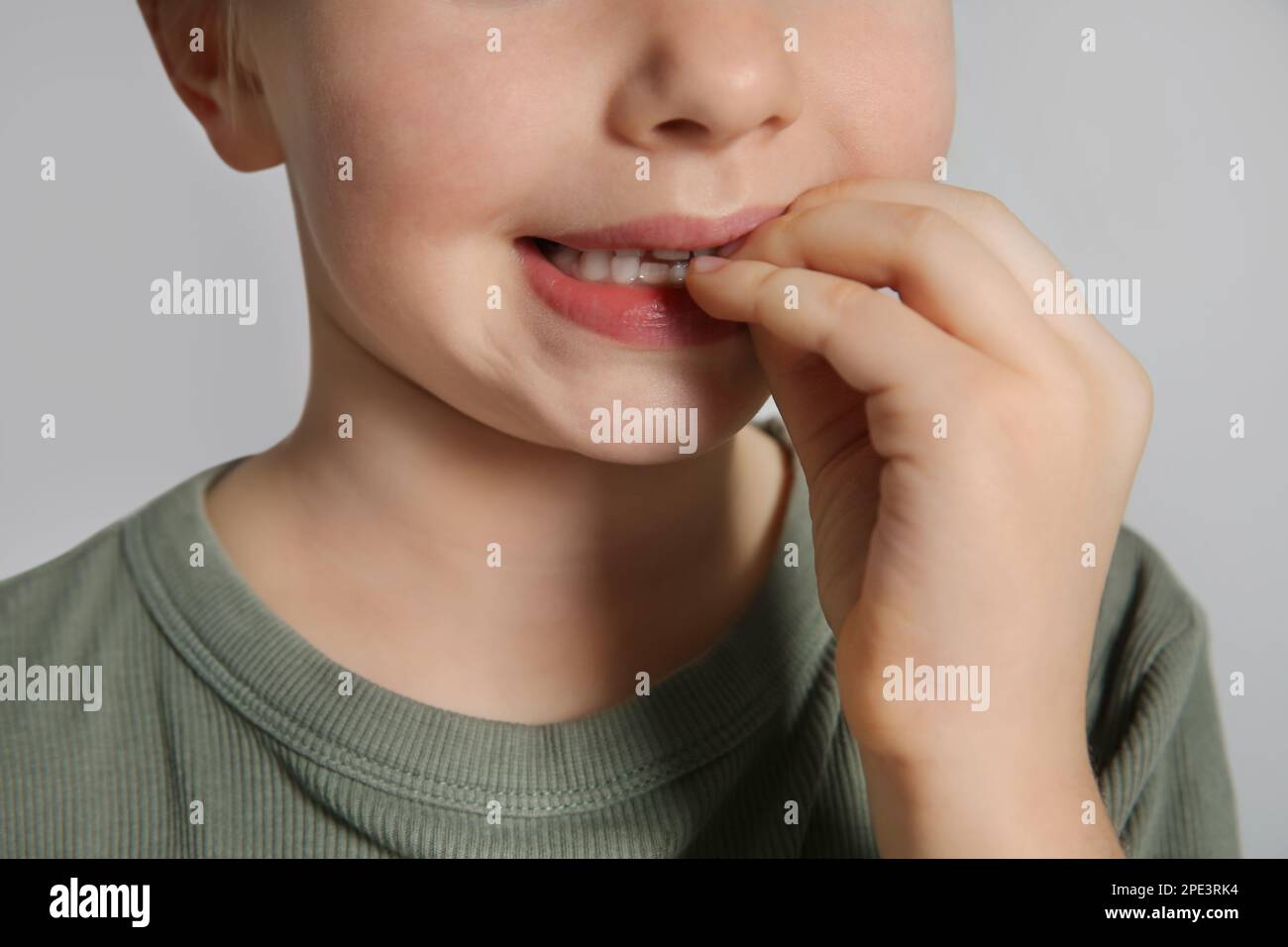 Girl biting her nail hi-res stock photography and images - Alamy