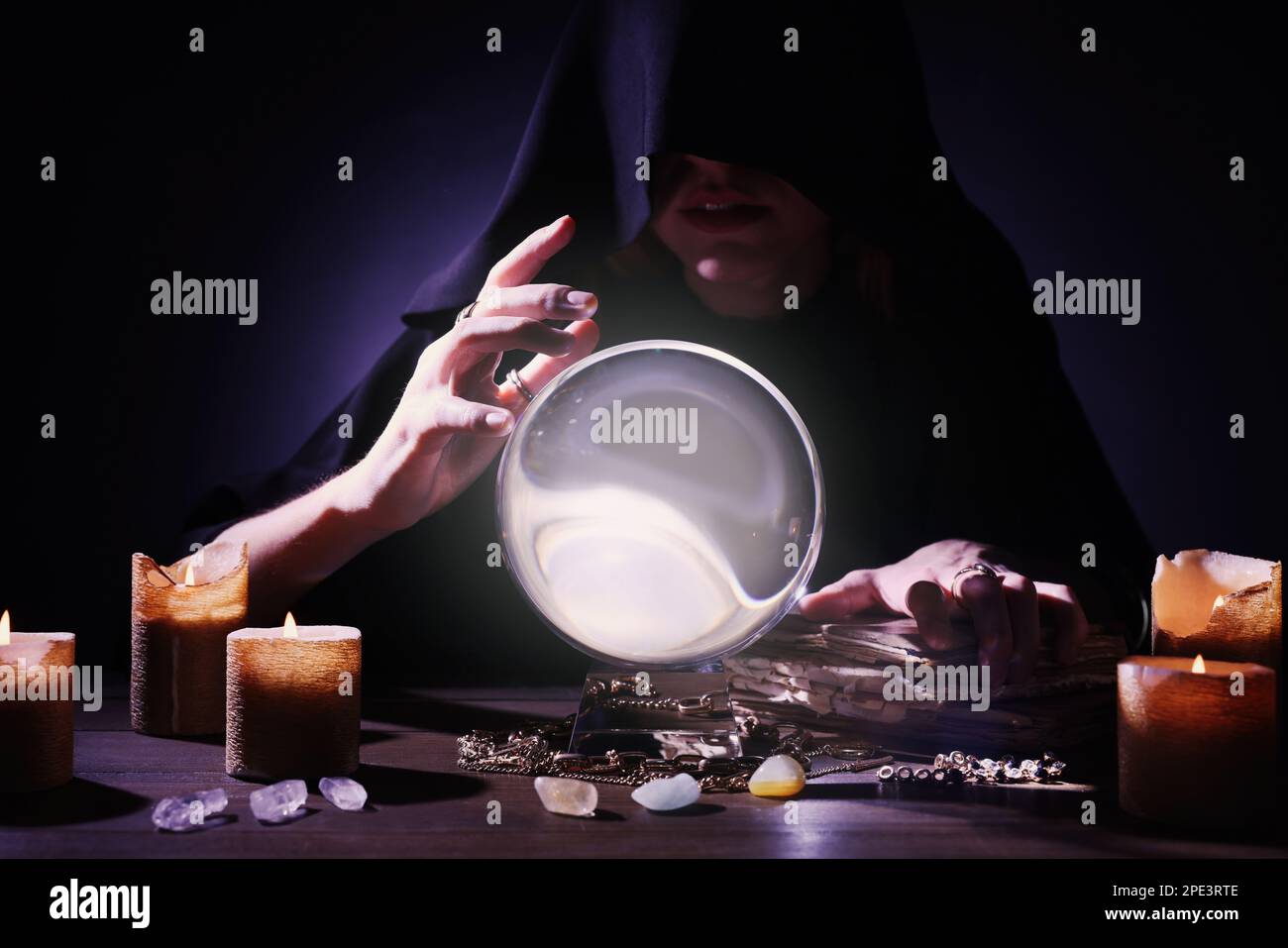 Soothsayer Using Crystal Ball To Predict Future At Table In Darkness