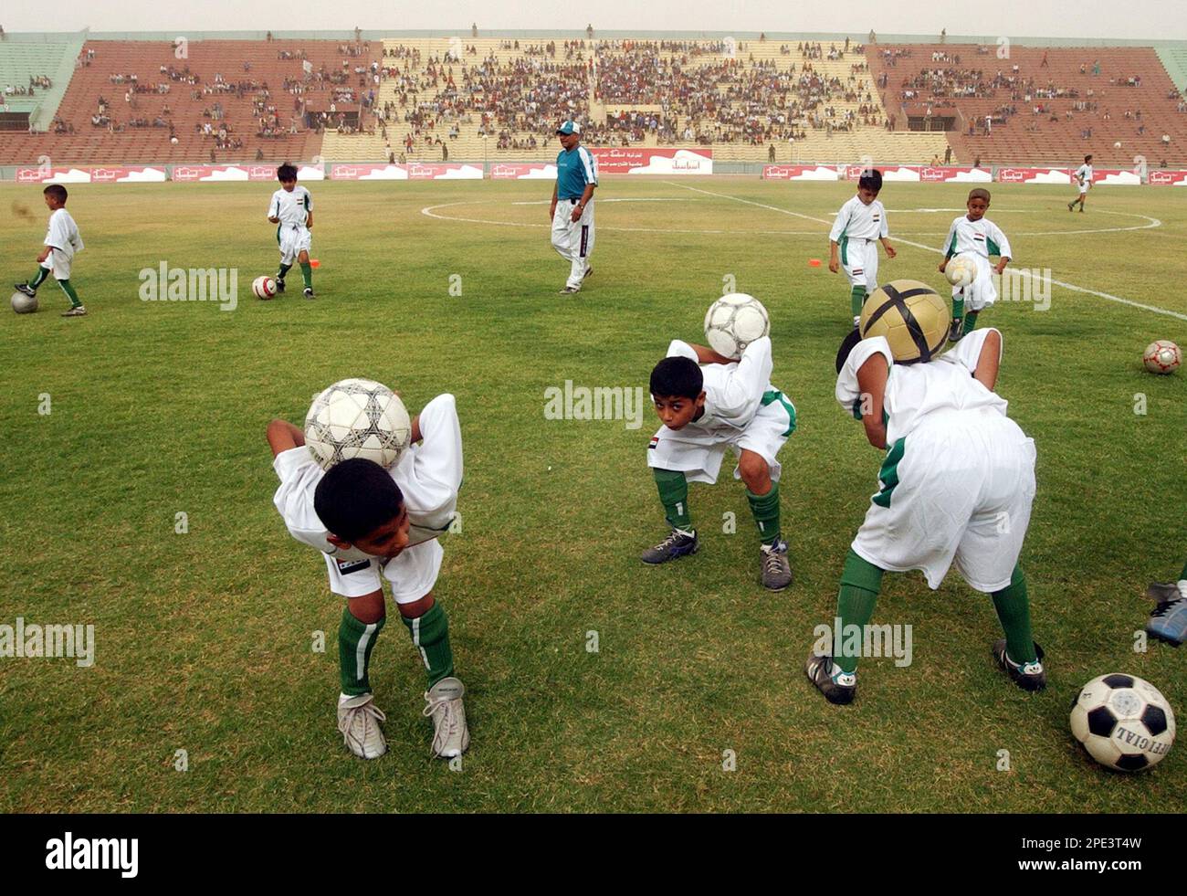 Iraqi children show their soccer skills at the re-opening ceremony of ...