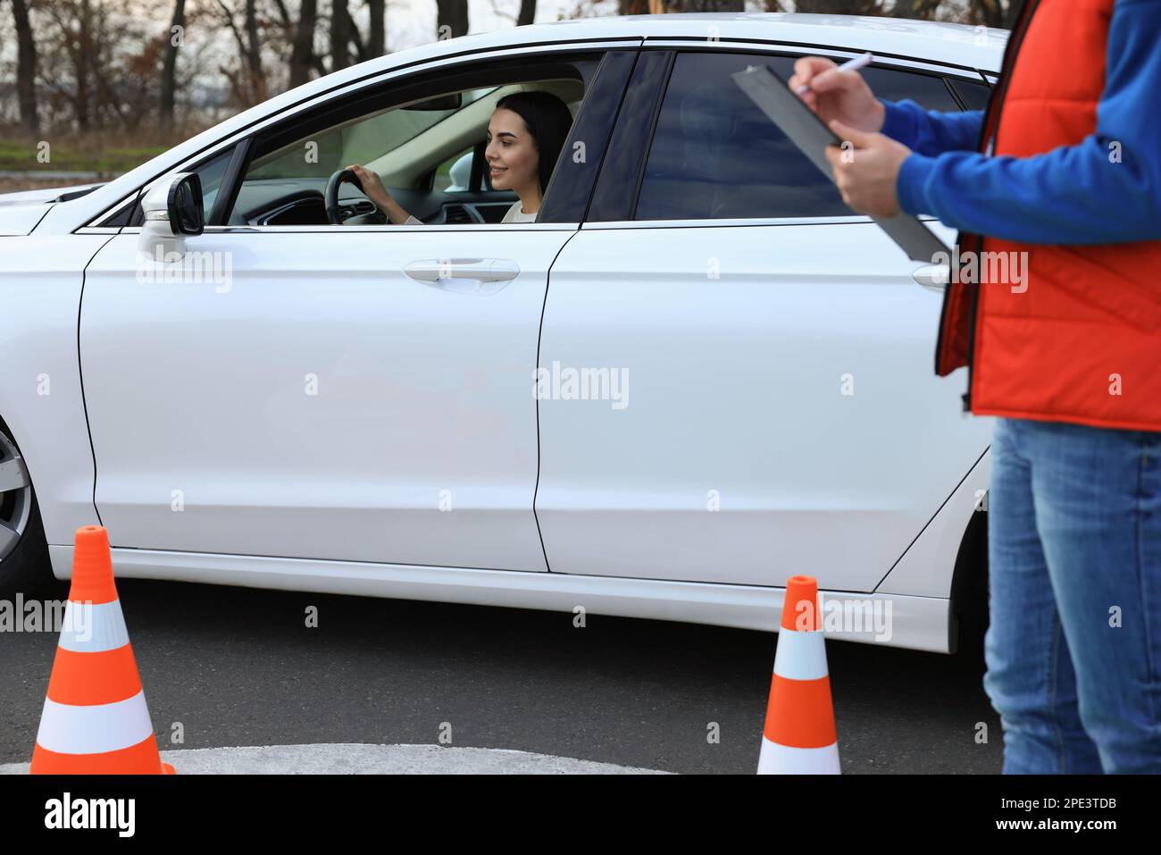 Young woman passing driving school exam at test track Stock Photo - Alamy
