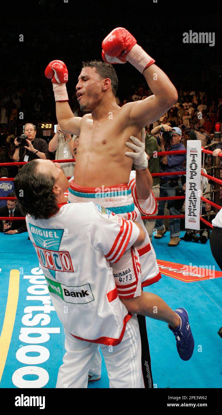 Miguel Cotto, above, of Puerto Rico, is lifted in the air by his father ...