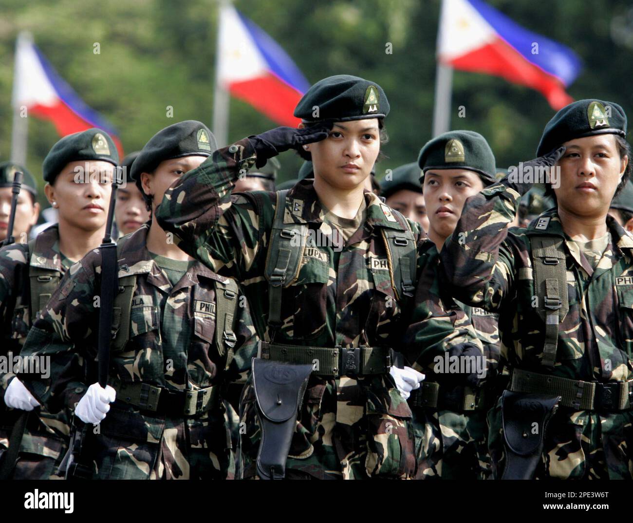Filipino female troopers salute as they mark the 107th Philippine ...