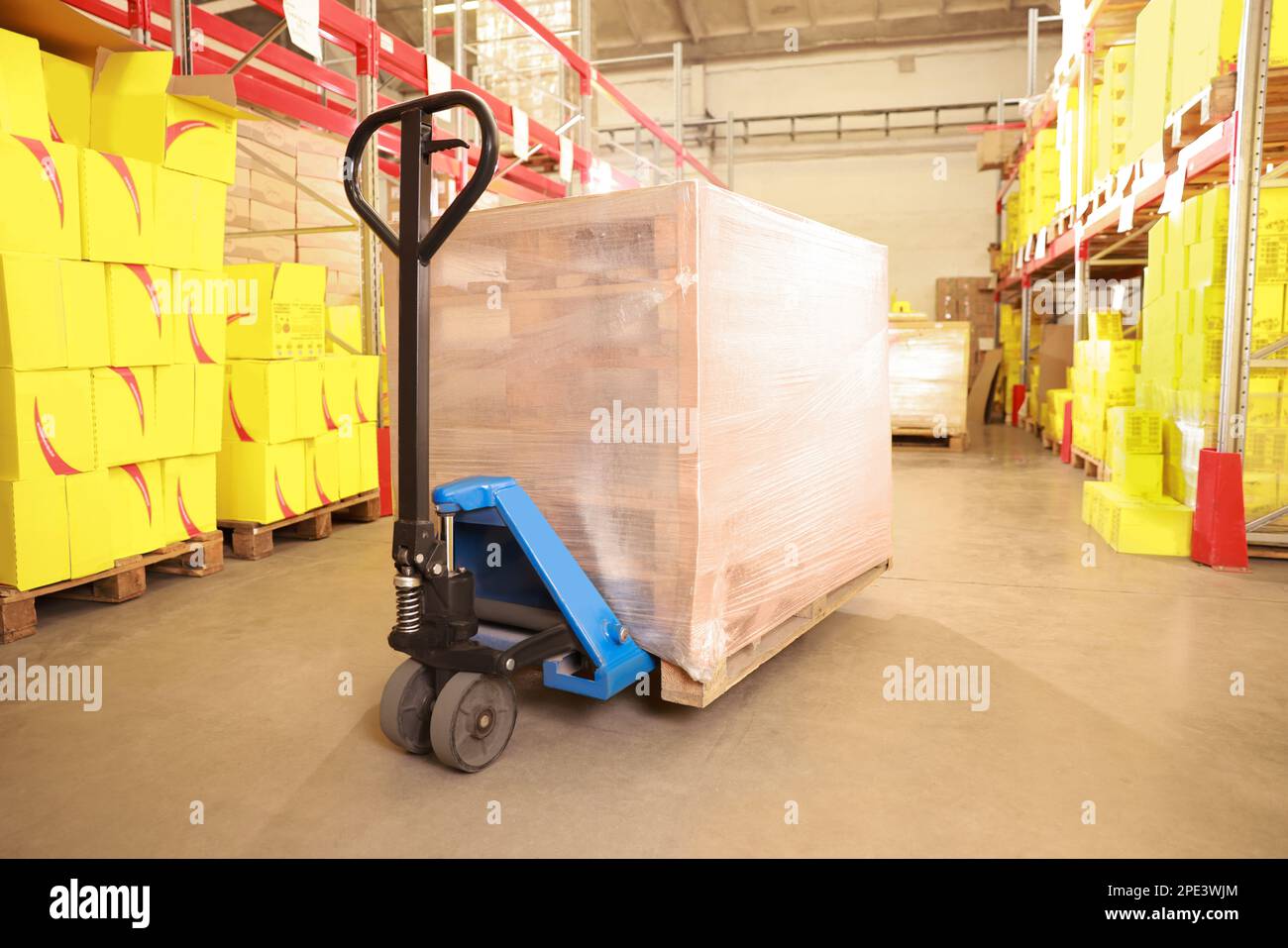 Wooden pallets wrapped in stretch on manual forklift indoors Stock ...