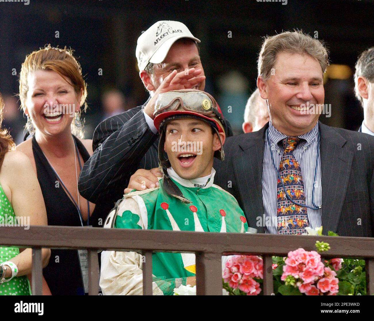 Jockey Jeremy Rose, front, reacts in the winner's circle with, from ...
