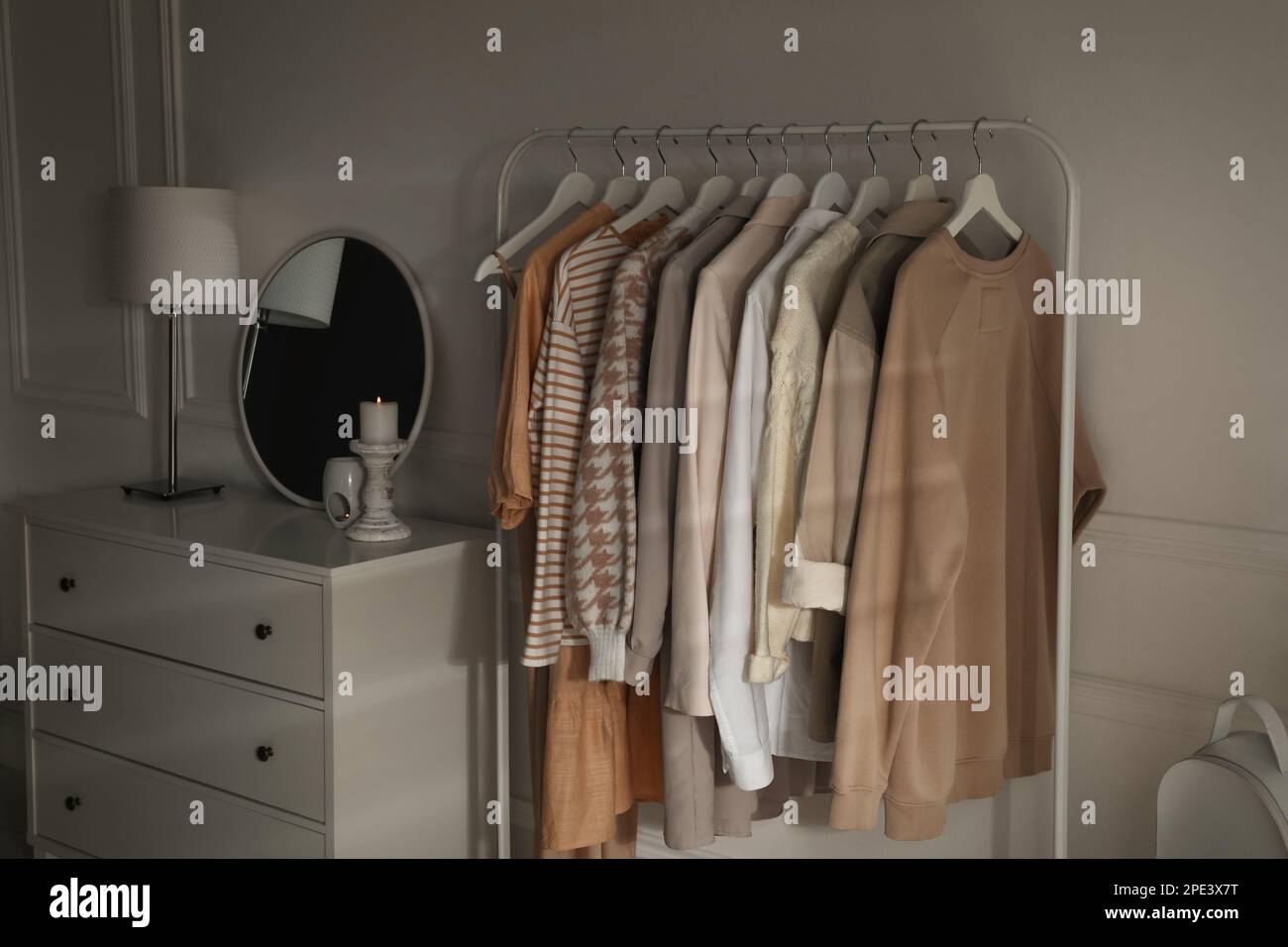 Modern dressing room interior with rack of stylish clothes Stock Photo ...
