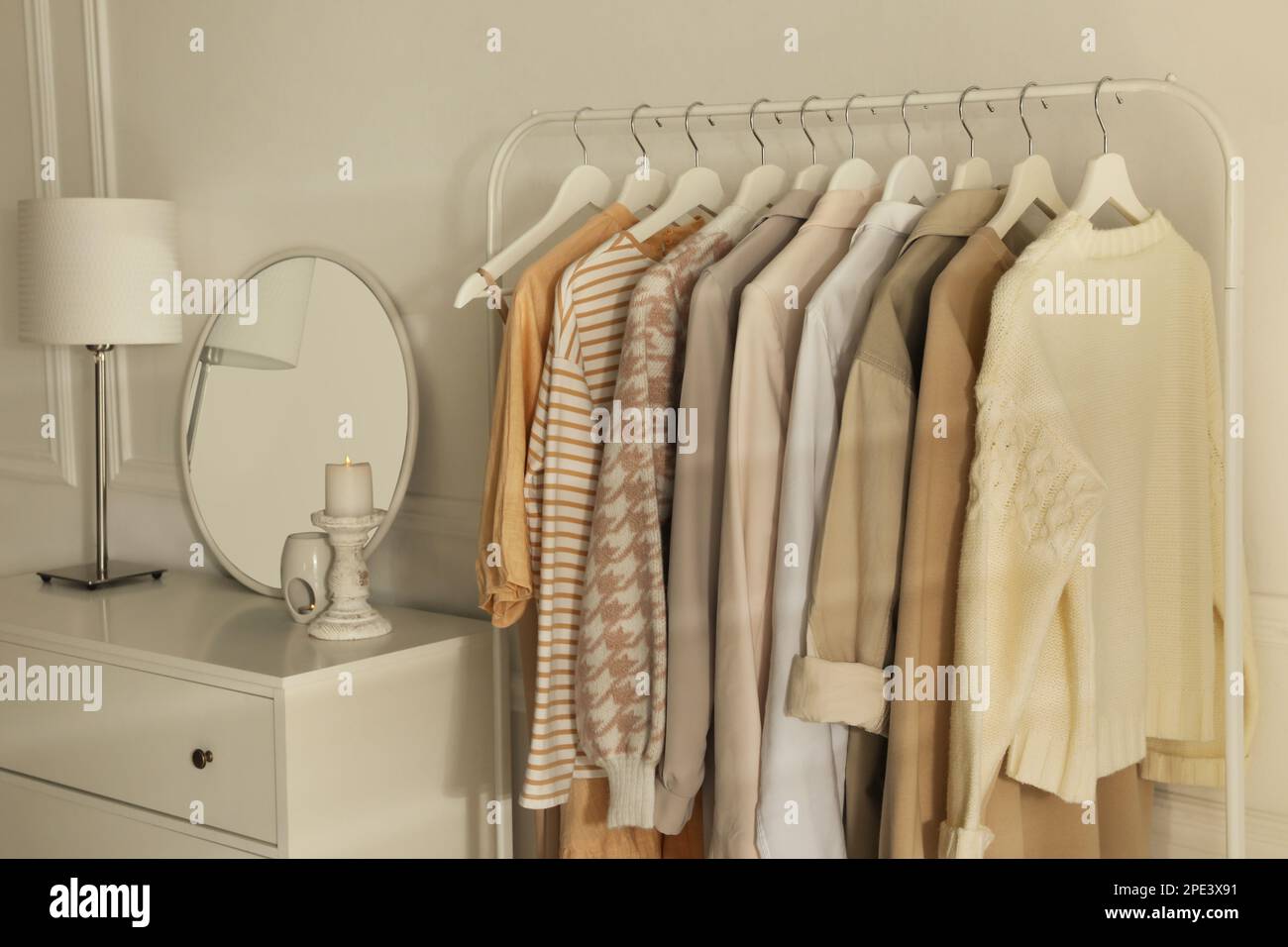 Modern dressing room interior with rack of stylish clothes Stock Photo ...