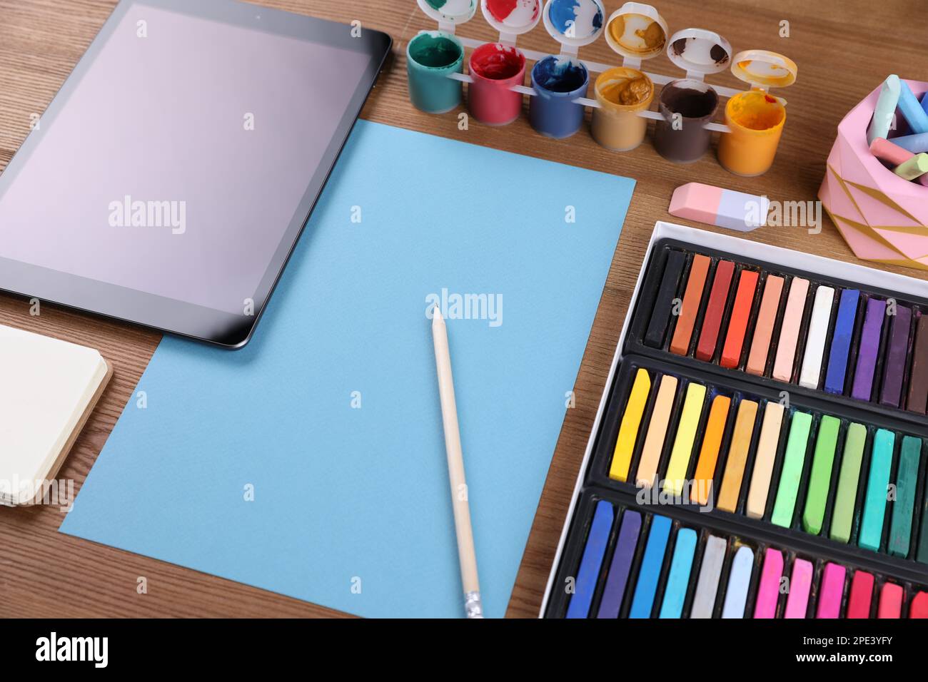 Blank sheet of paper, colorful chalk pastels, tablet and other drawing ...