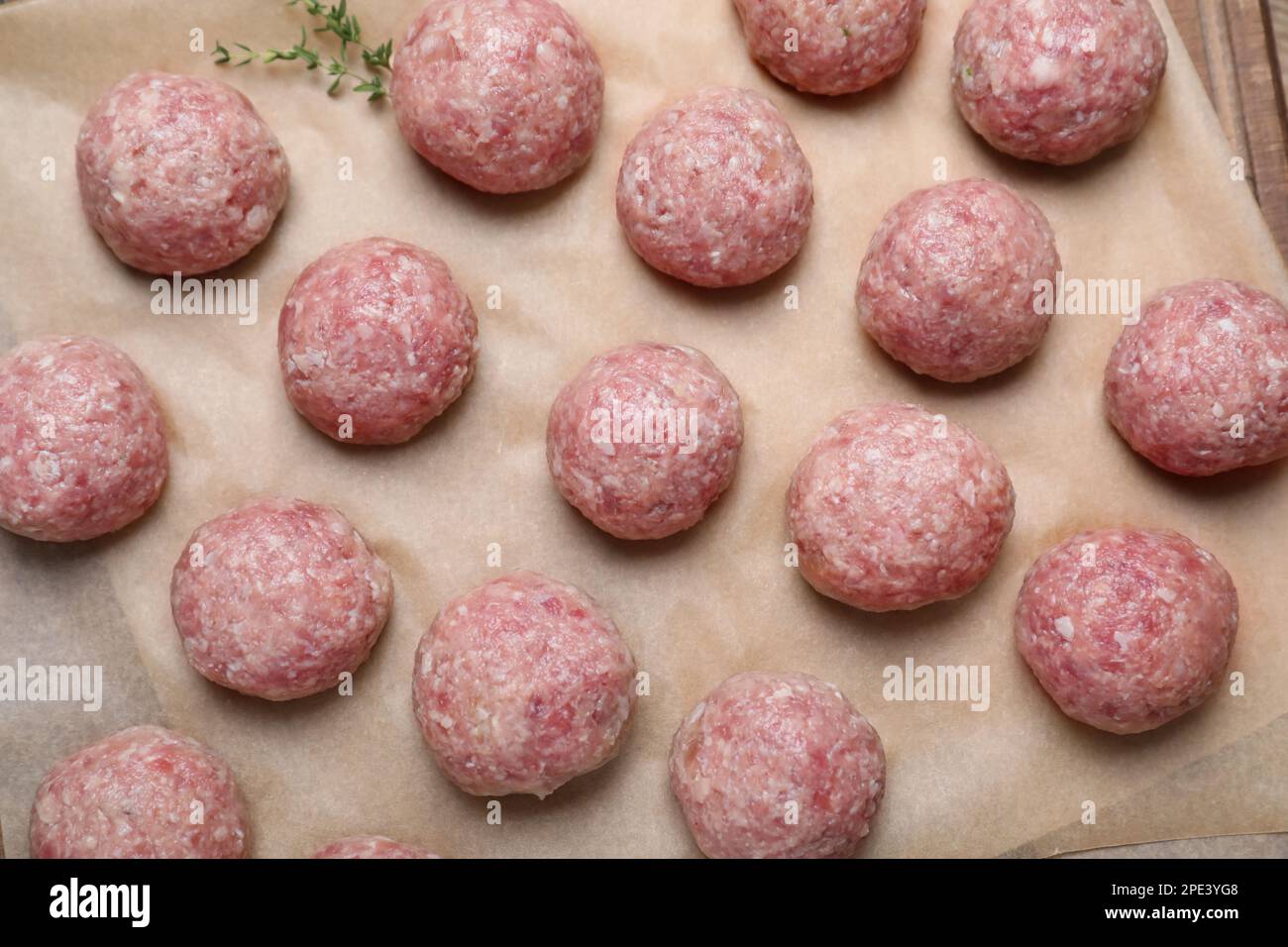Many fresh raw meatballs on parchment paper, flat lay Stock Photo - Alamy