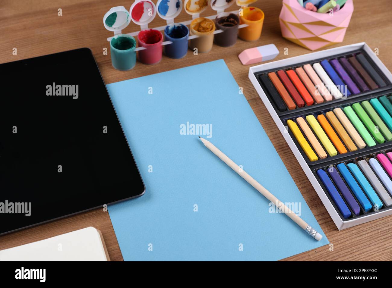 Blank sheet of paper, colorful chalk pastels, tablet and other drawing ...