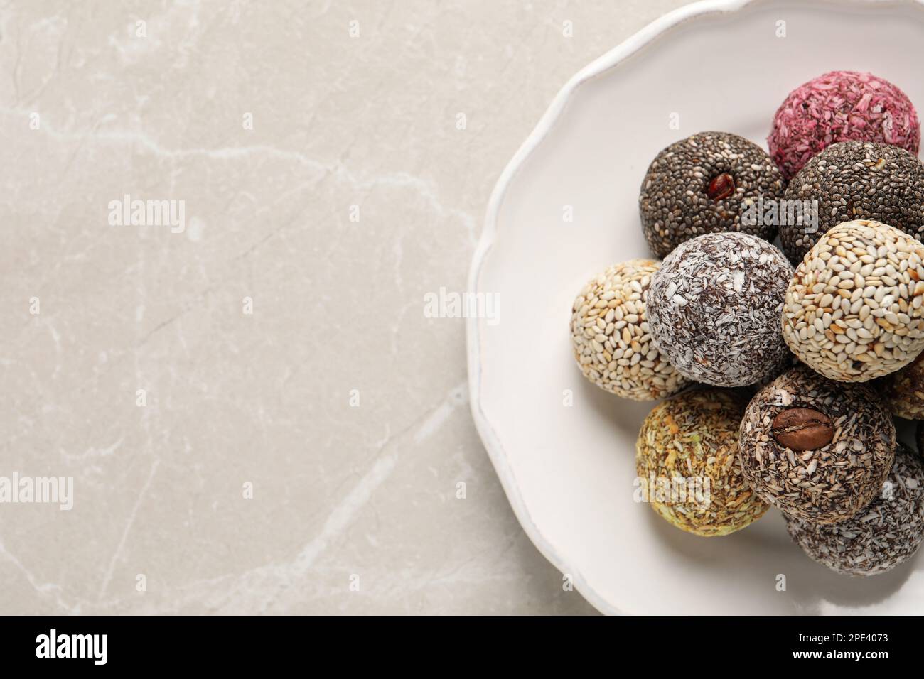 Different delicious vegan candy balls on light grey marble table, top ...