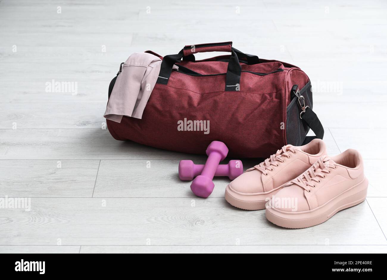 Sports bag and gym stuff on white floor Stock Photo - Alamy