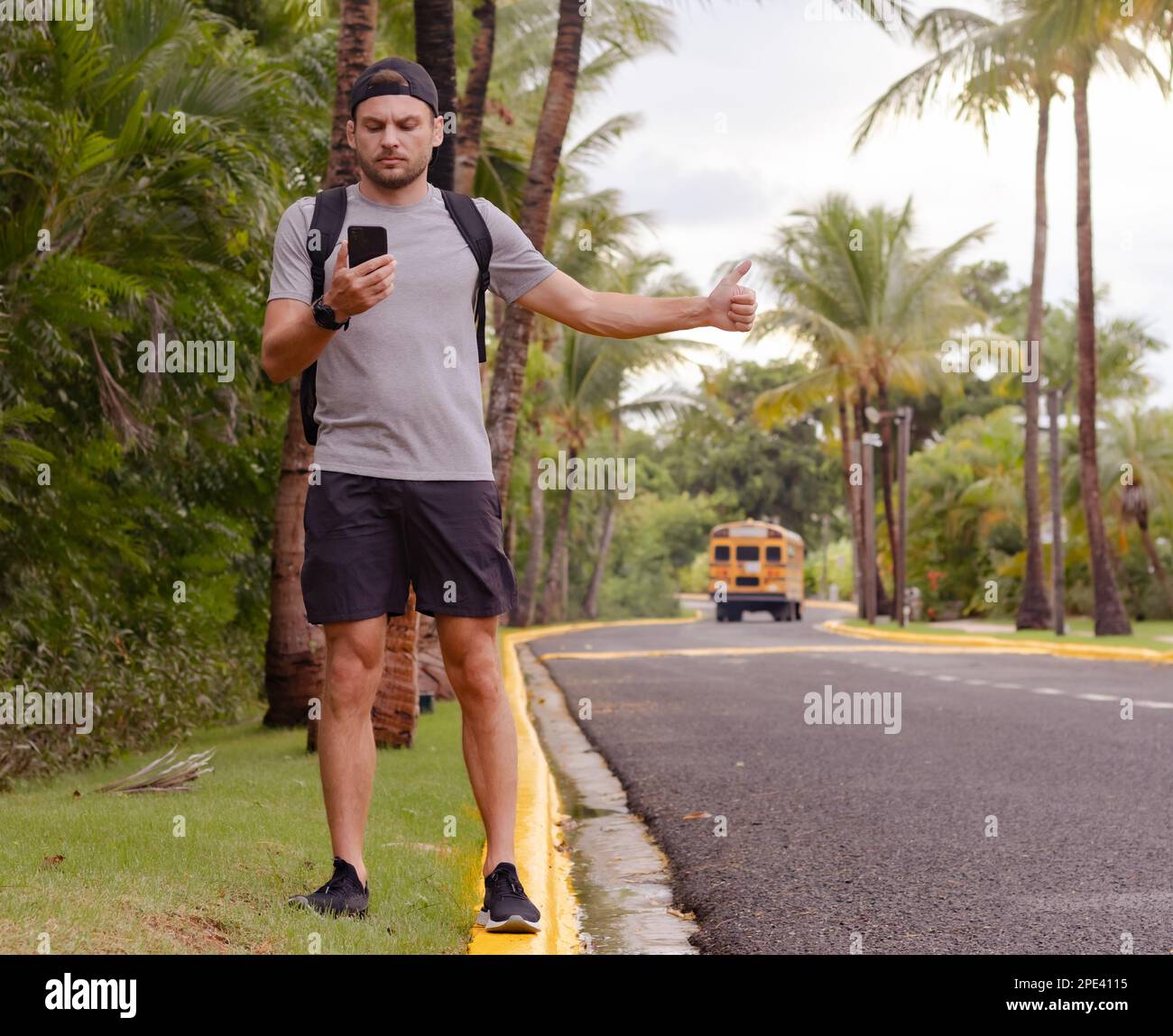 Tourist on road in tropical climate country missed bus and catching a ...