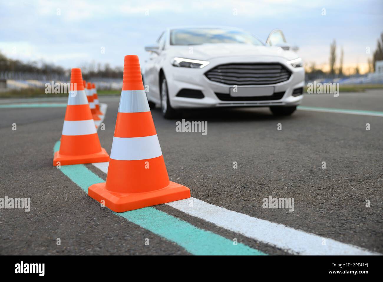 Modern car at test track, focus on traffic cone. Driving school Stock ...