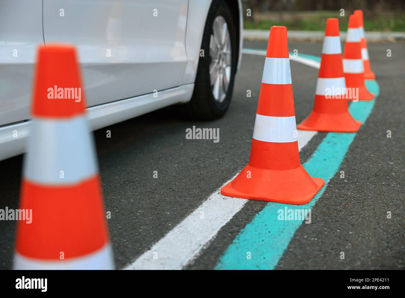 Modern car on test track with traffic cones, closeup. Driving school ...