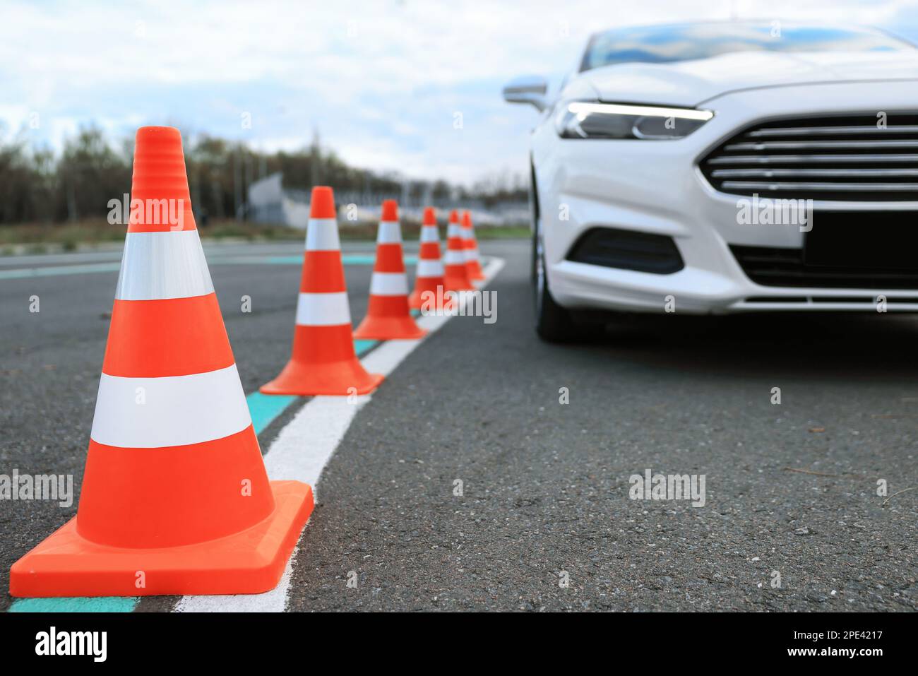 Modern car on test track with traffic cones, closeup. Driving school ...