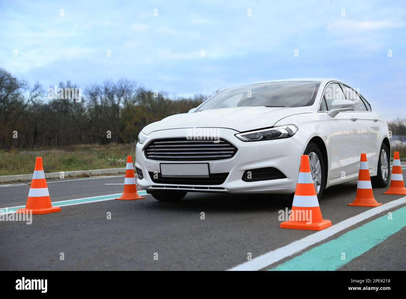Modern car on test track with traffic cones. Driving school Stock Photo ...