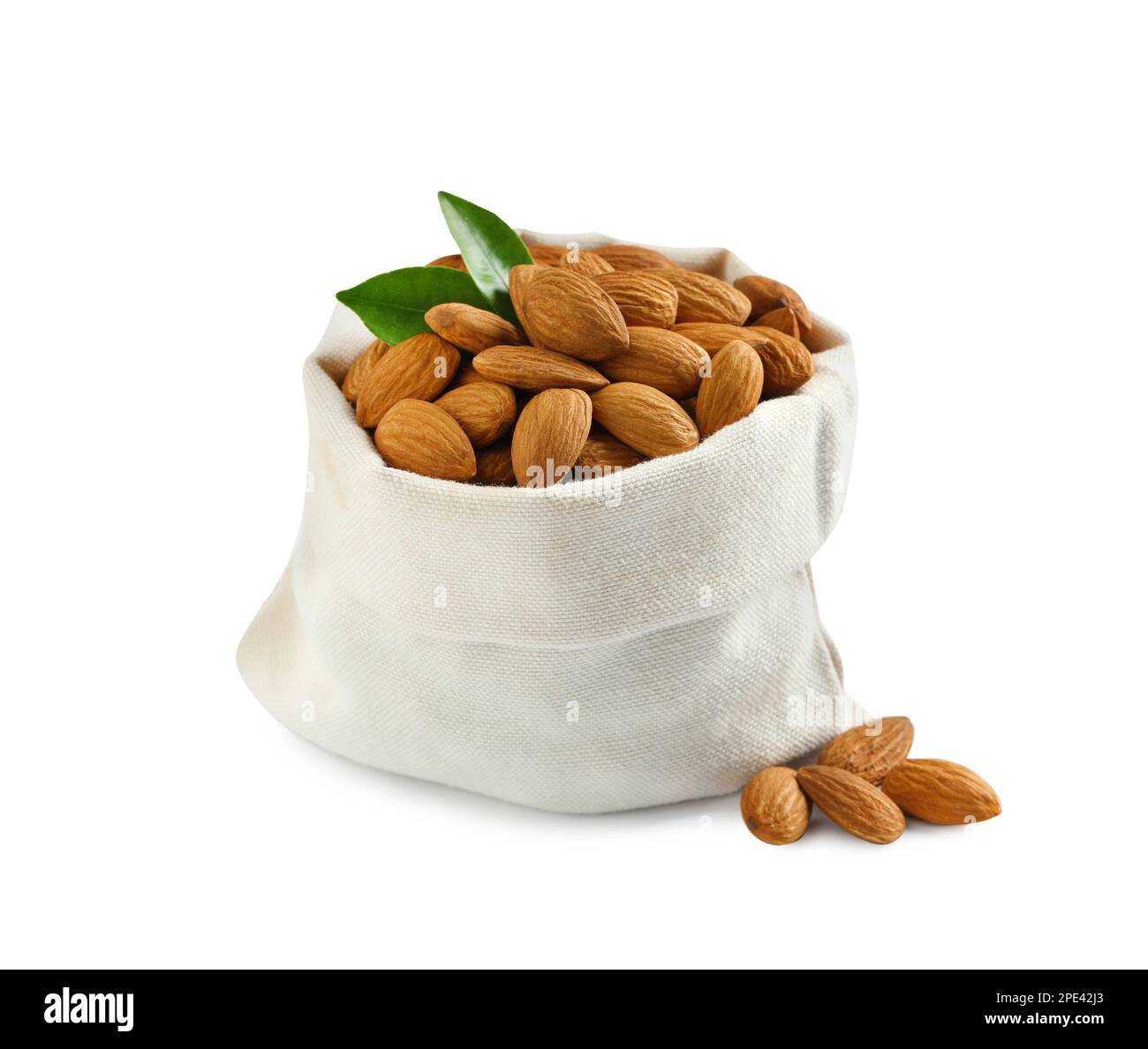 Sack with organic almond nuts and green leaves on white background ...