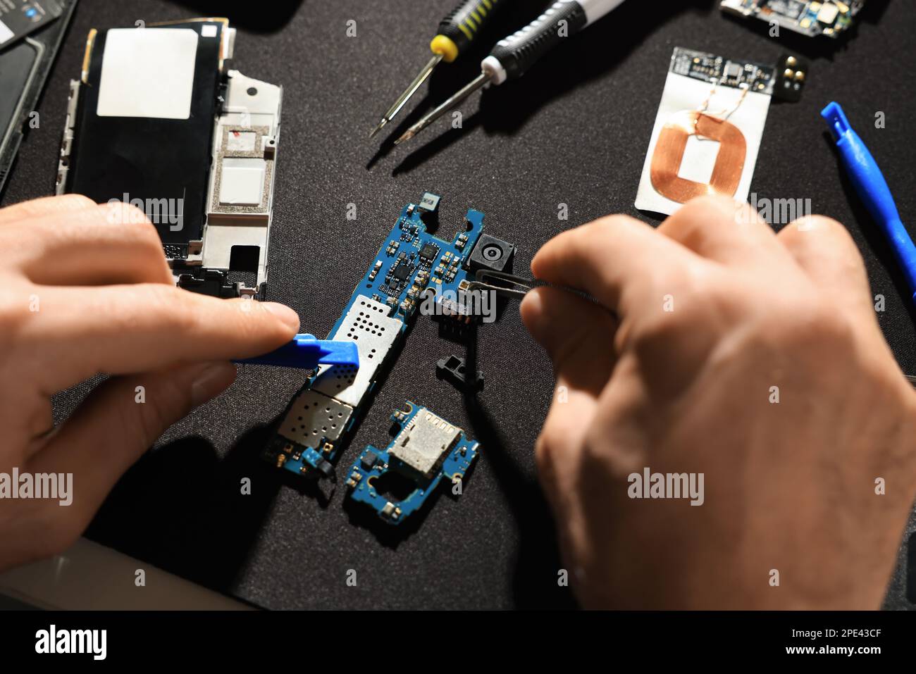 Technician repairing broken smartphone hi-res stock photography and ...